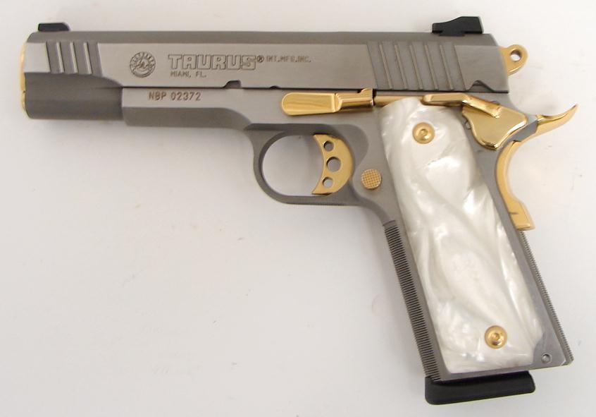 Taurus PT1911 .45 ACP caliber pistol. Stainless model with gold accents ...
