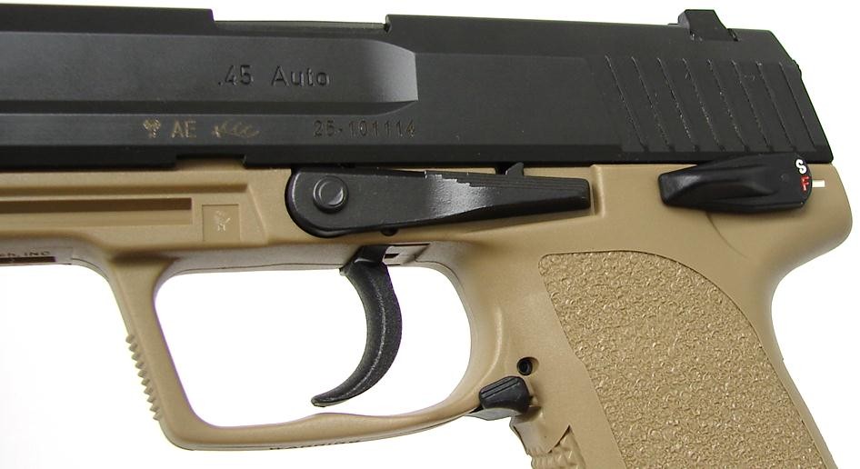 Heckler & Koch USP .45 ACP caliber pistol. Desert tan frame with 3 hi ...