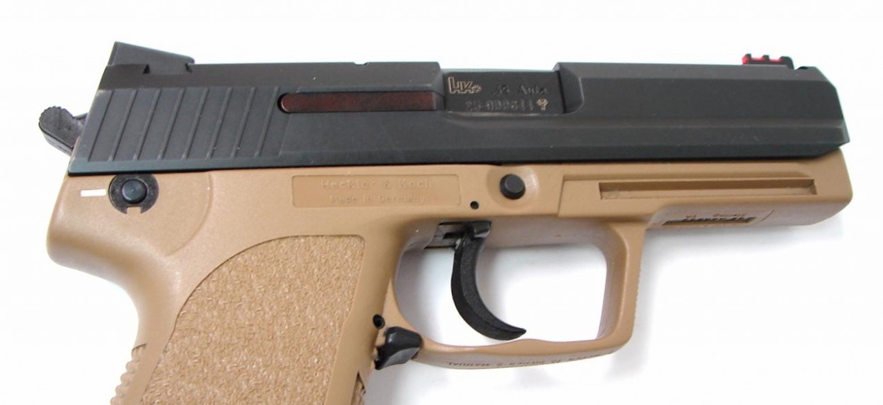 Heckler & Koch USP .45 ACP caliber pistol. Custom combat model with tan ...
