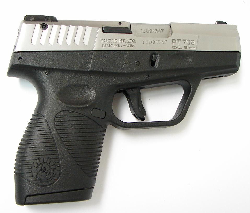 Taurus PT 709 9MM caliber pistol. Two tone model with fixed sights, box ...